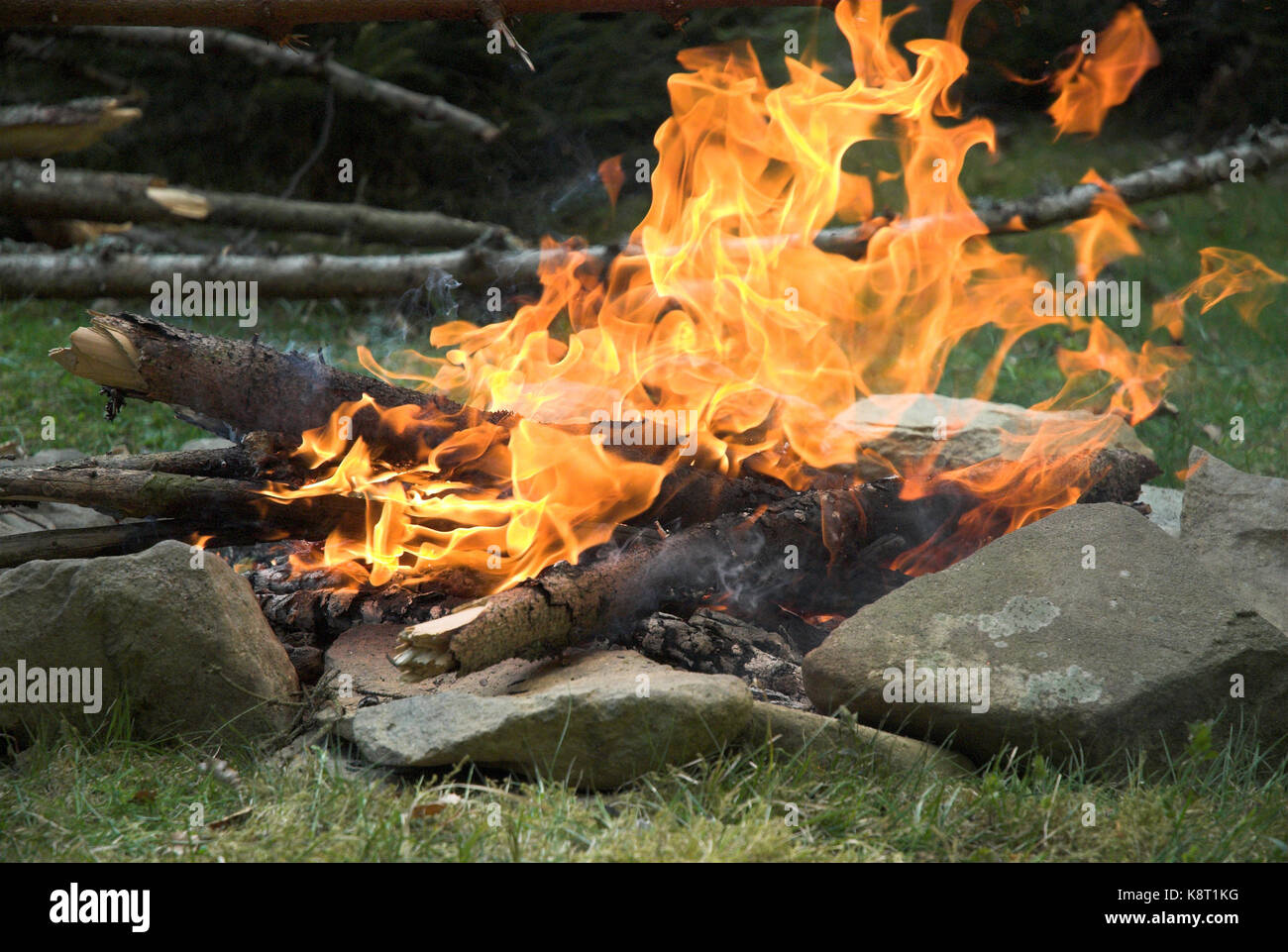 Campfire in the morning. Huge flames. Stones in front of fire Stock ...