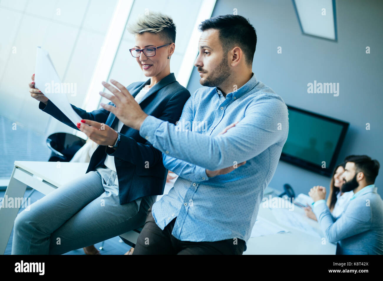 Portrait of architects having discussion in office Stock Photo - Alamy