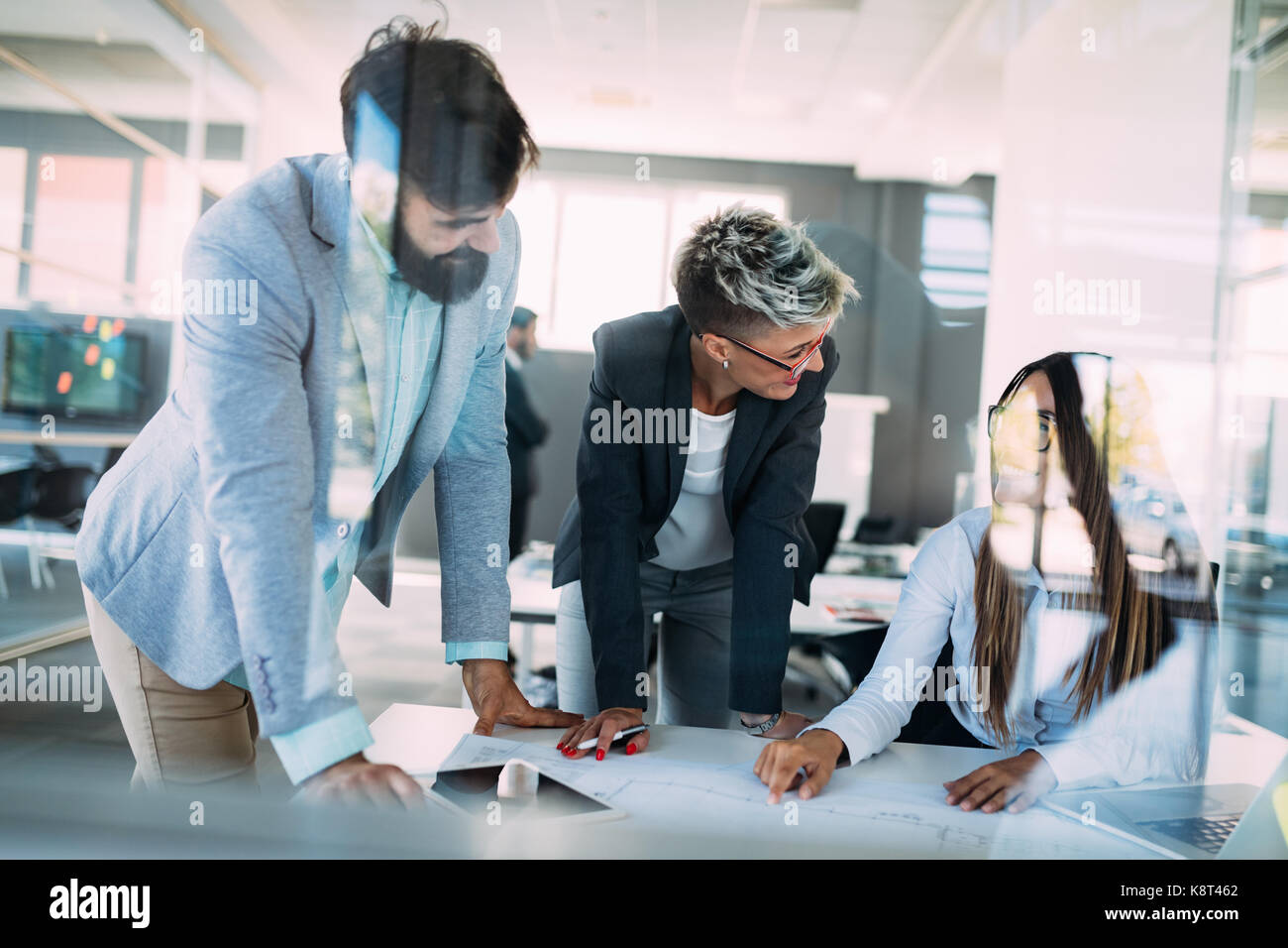 Portrait of architects having discussion in office Stock Photo - Alamy