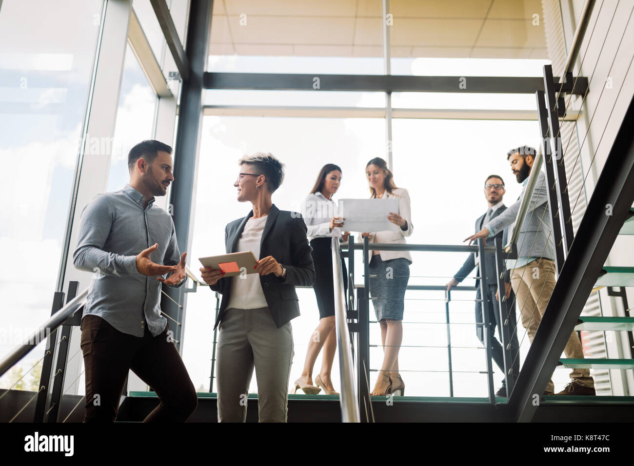Picture of architects talking about project in hall Stock Photo - Alamy