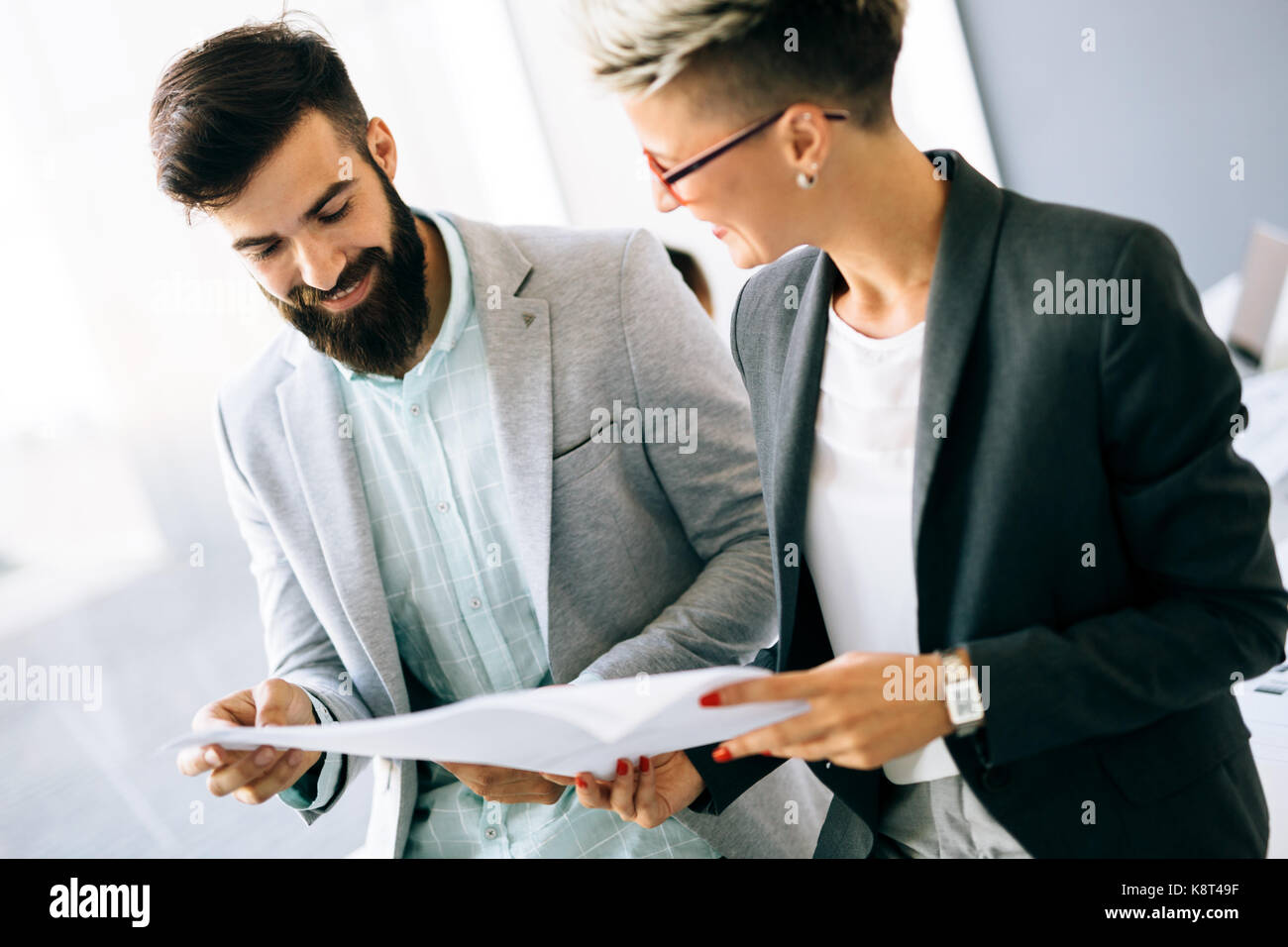 Picture of young architects discussing about project Stock Photo - Alamy