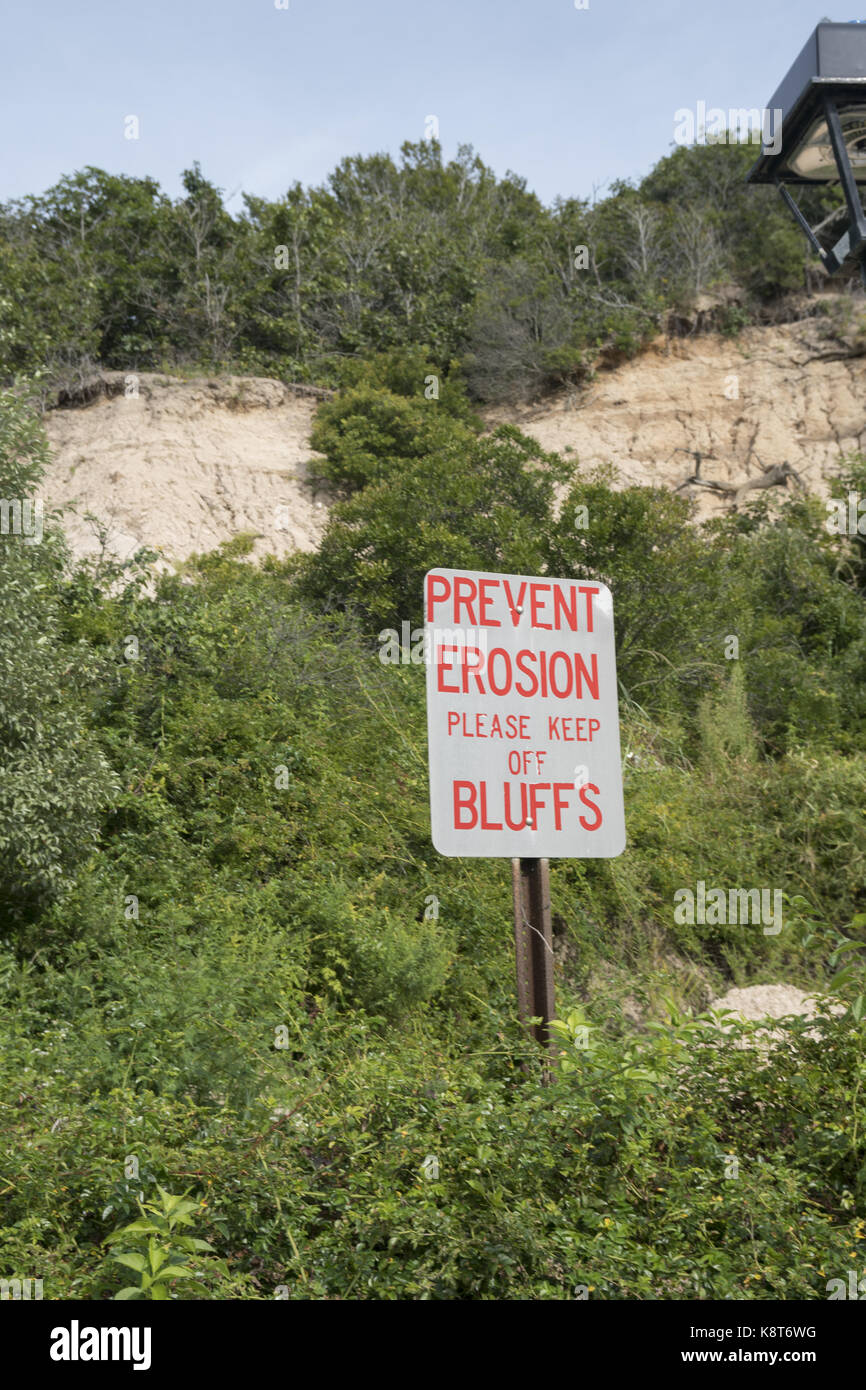 Erosion warning sign by some bluffs by a beach on Long Island Sound in ...