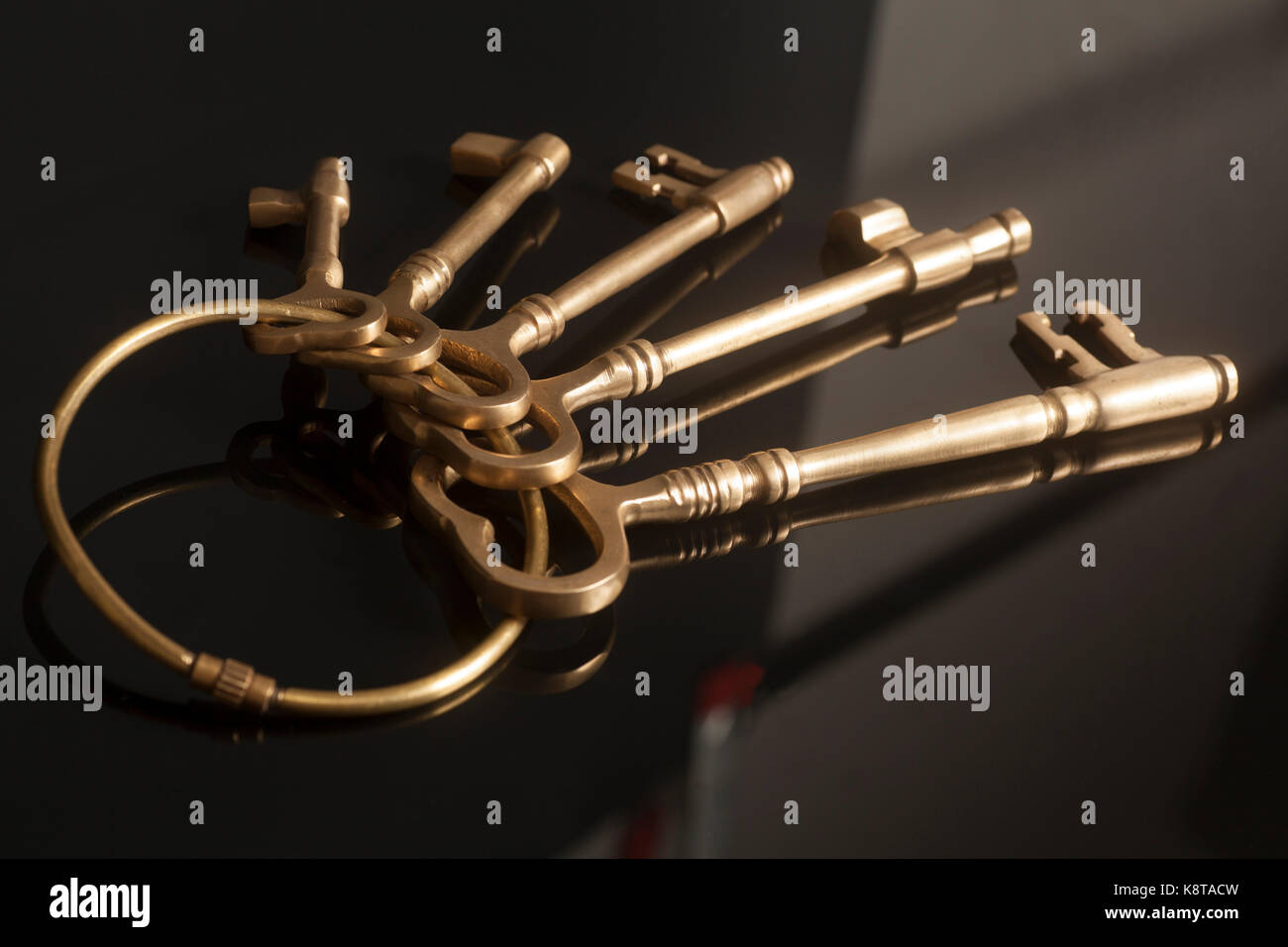 Vintage golden keys on a keyring on black background Stock Photo - Alamy