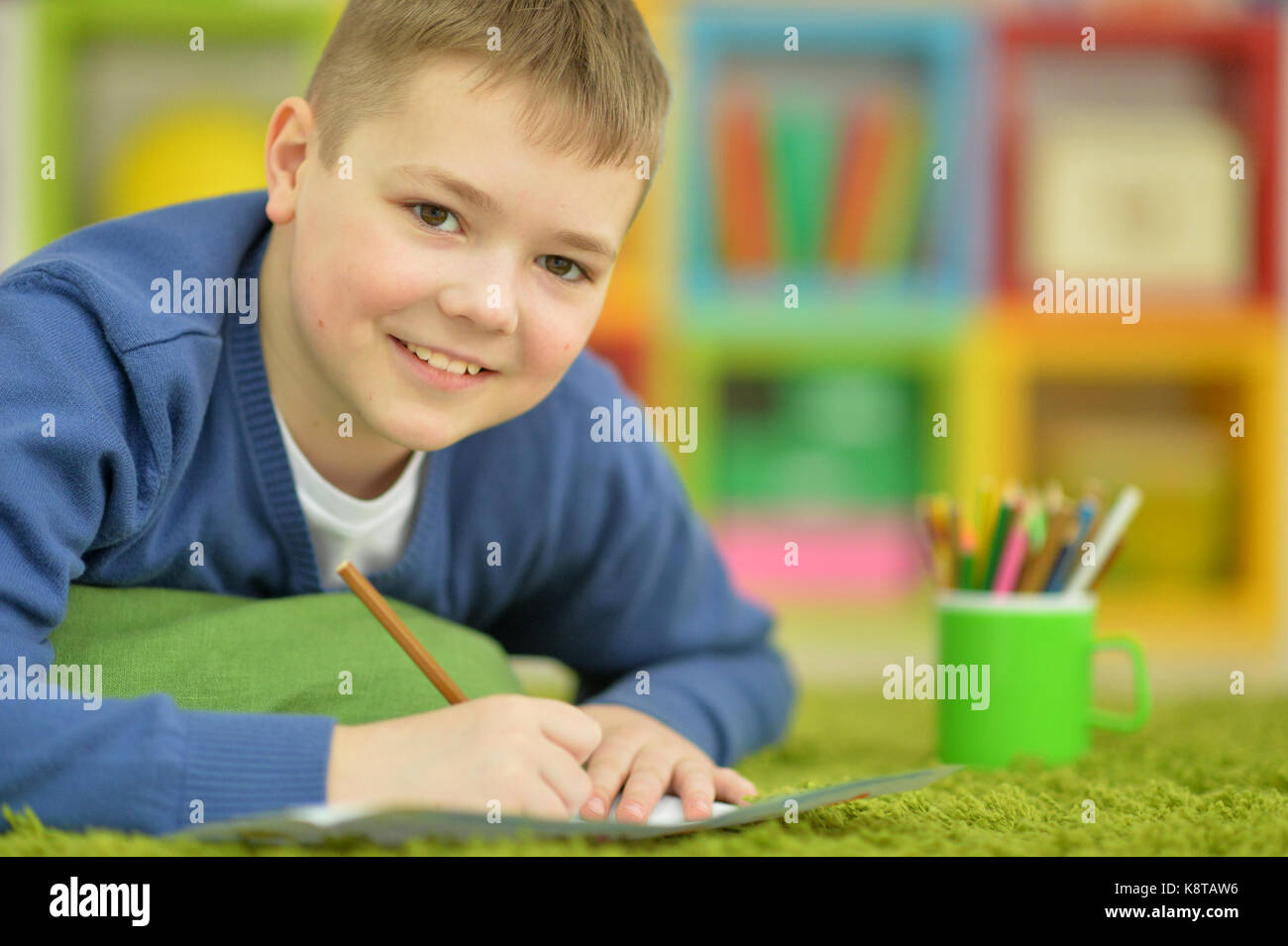 Portrait of a boy drawing with pencil Stock Photo - Alamy