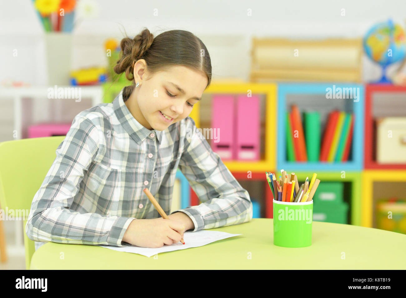 Little schoolgirl doing homework at her room Stock Photo - Alamy