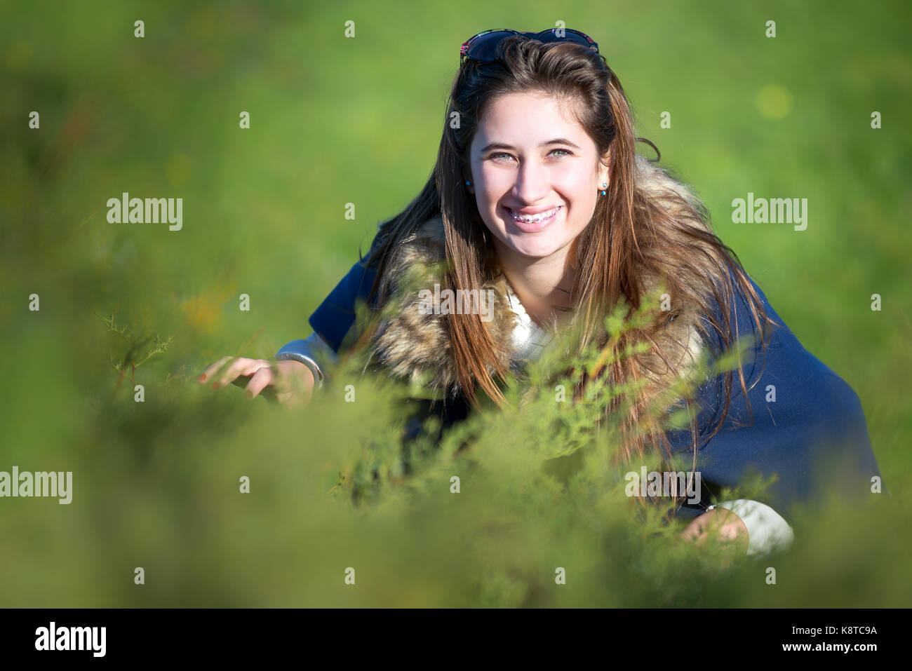 Beautiful and happy young girl posing outdoors Stock Photo - Alamy