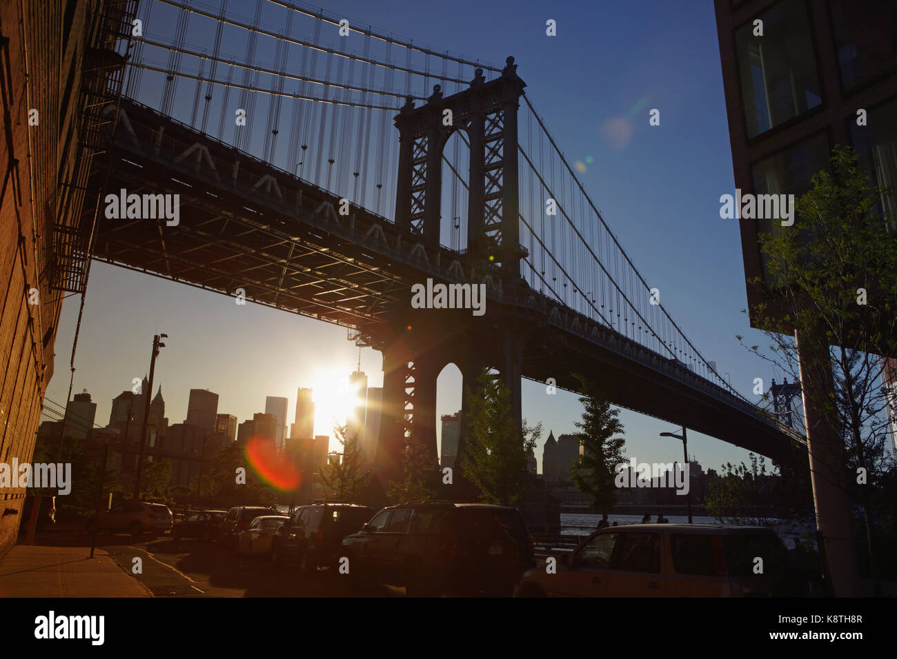 Sunset flare under the Manhattan Bridge in DUMBO Brooklyn waterfront ...