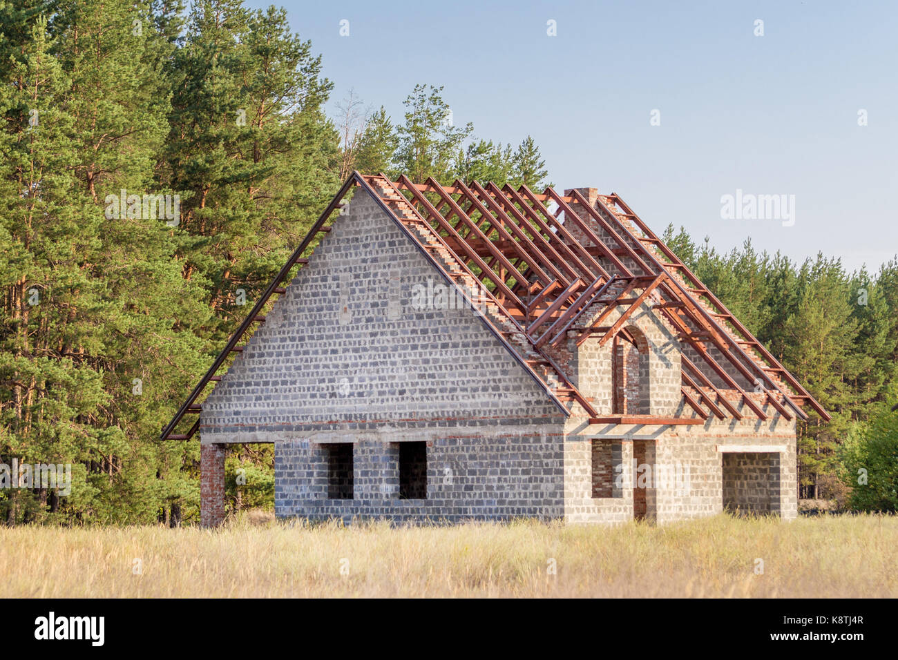 Unfinished house of foamed concrete with metal roof construction at ...