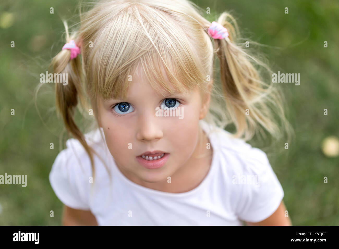 Close up portrait of cute adorable little blonde caucasian girl in a ...