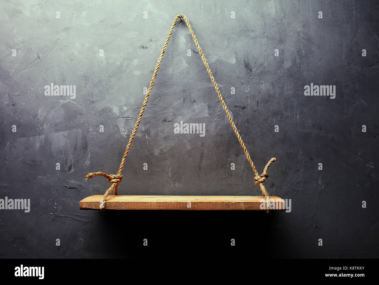 Empty old wood shelf hanging on rope on textured wall background Stock ...