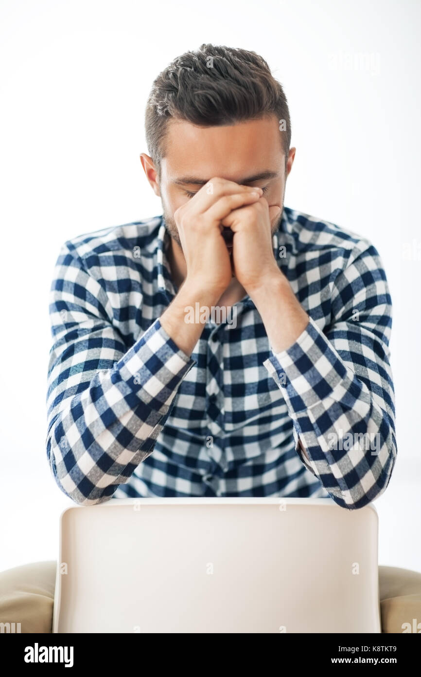 Portrait of stressed despair man closed face by two hands on white ...