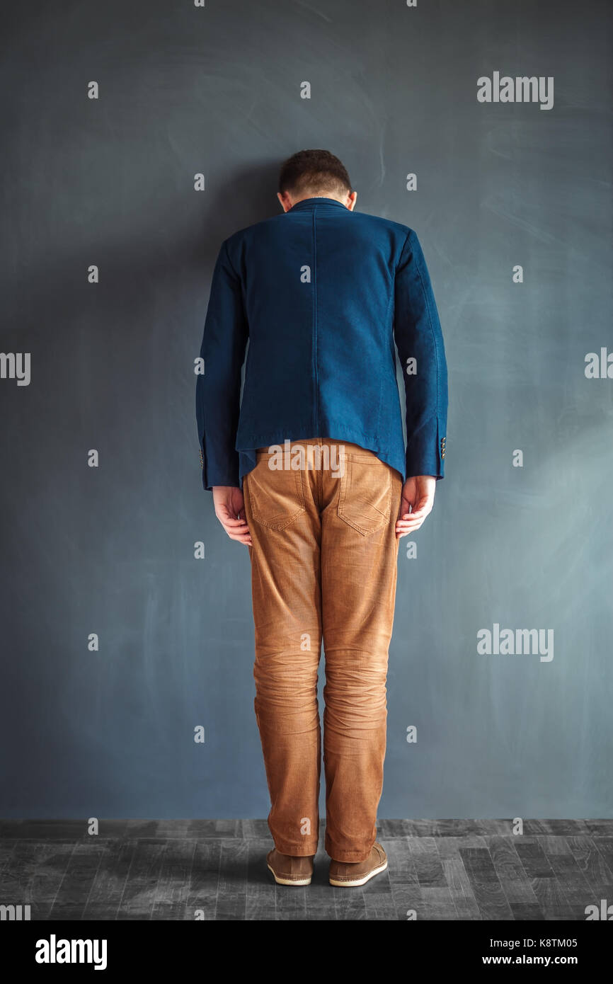 Rear view upset man standing hi-res stock photography and images - Alamy