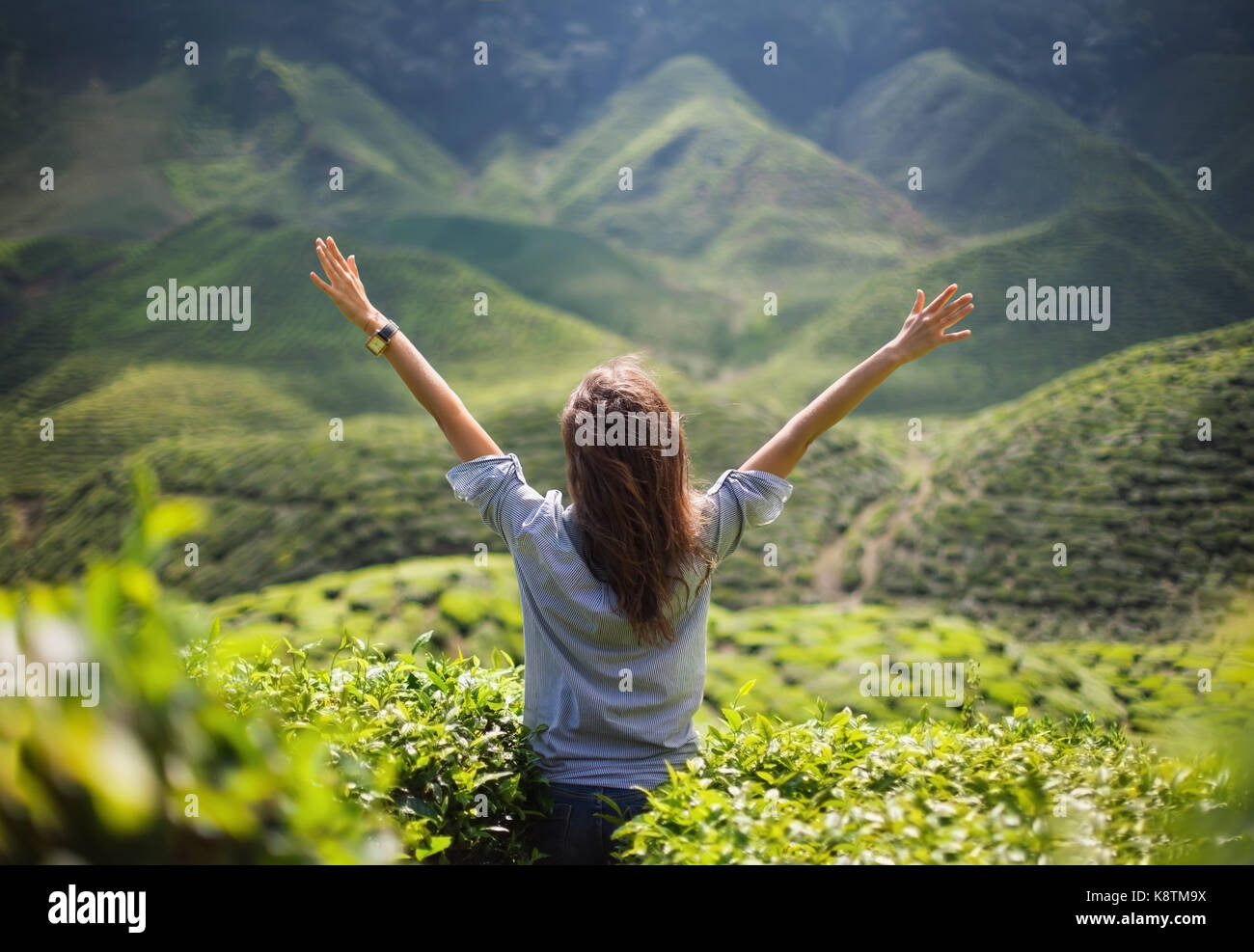 freedom girl with hands up in mountains Stock Photo - Alamy