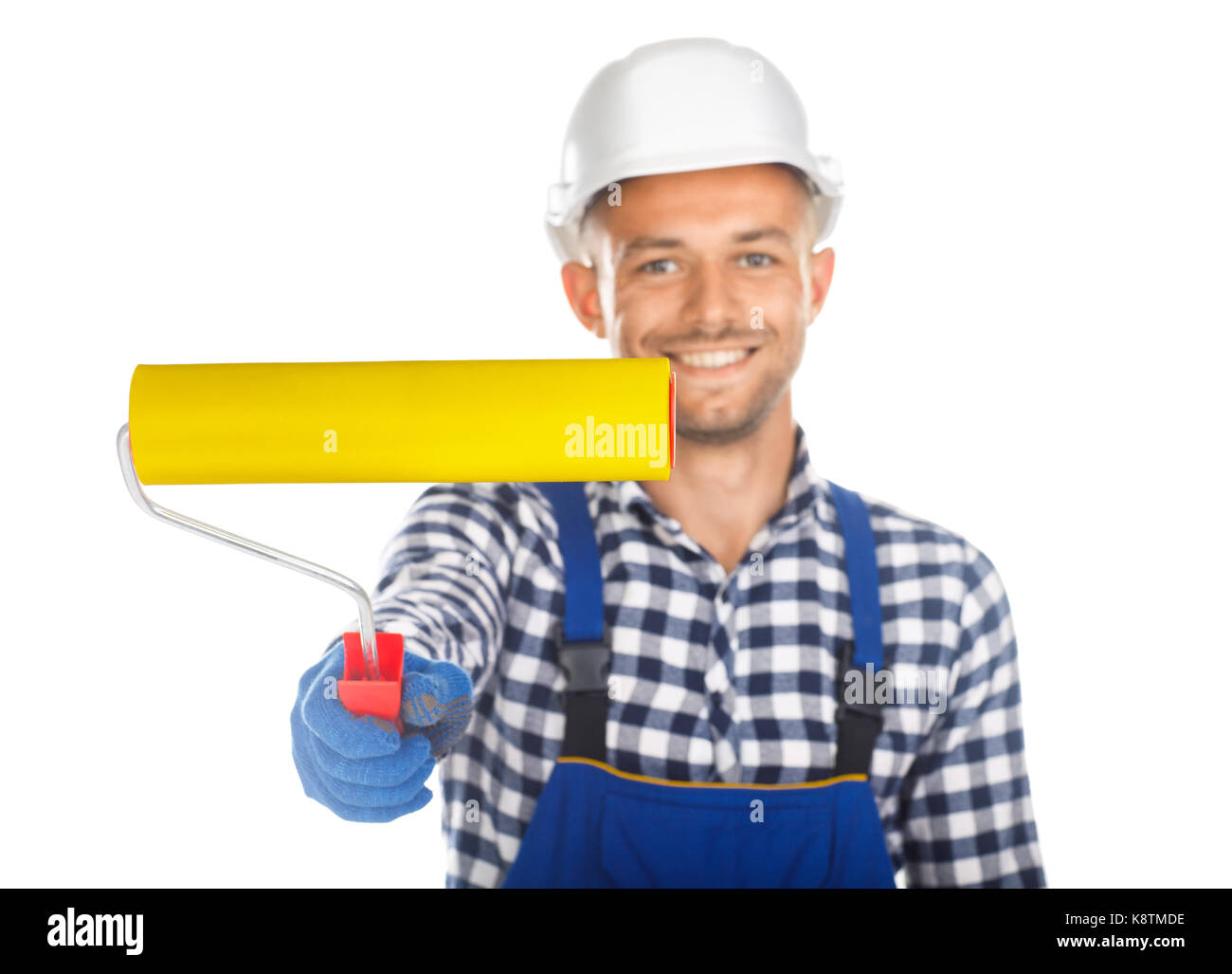 Smiling handsome painter with paint roller isolated on white background ...