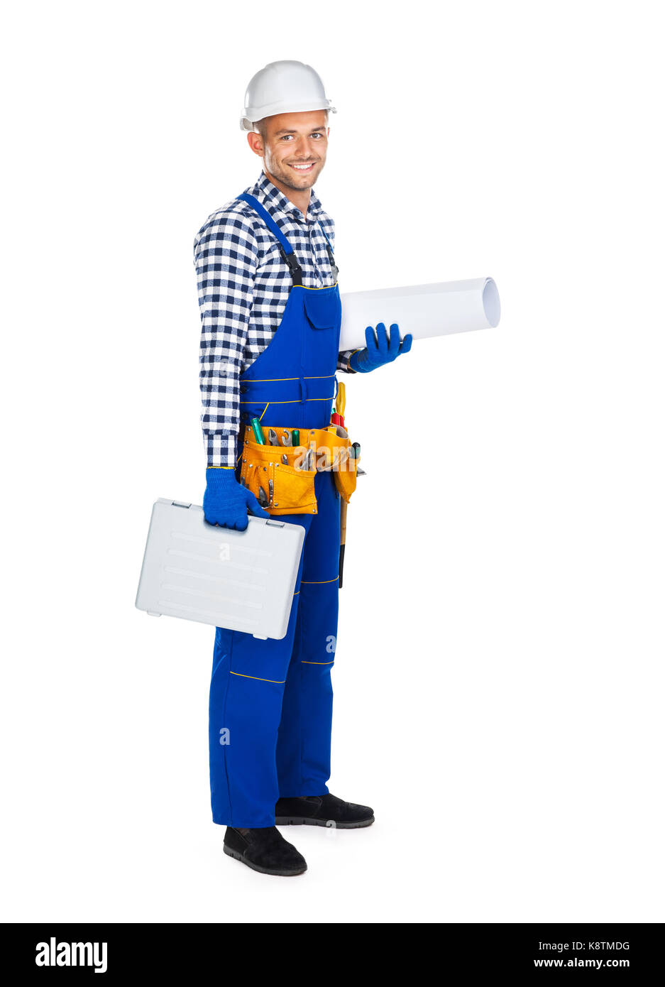 Side view of happy construction worker in uniform with toolbox and ...