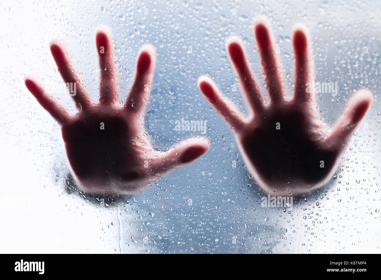 Silhouettes of two right hands behind wet glass Stock Photo - Alamy