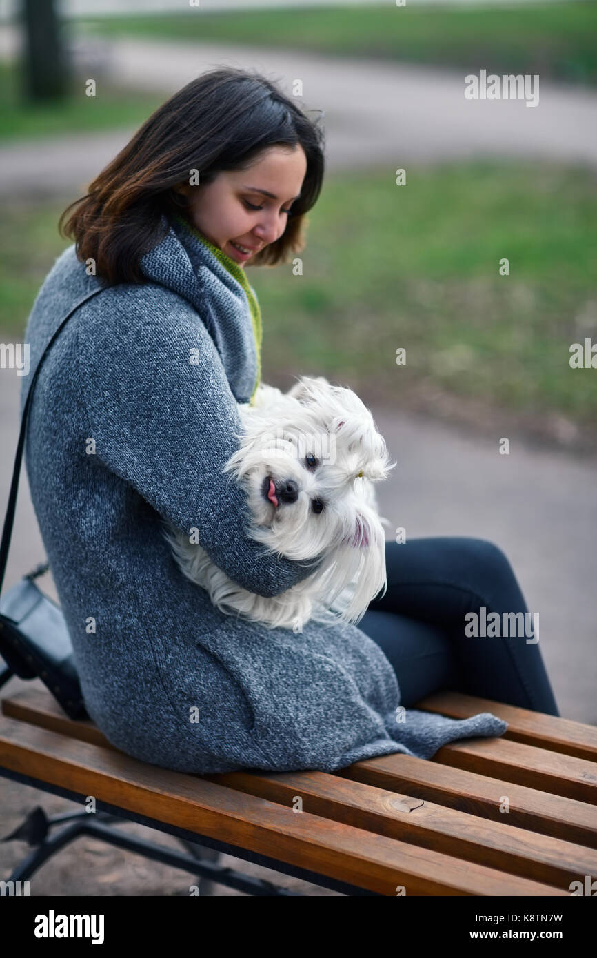 Funny cute dog with tong out and her owner Stock Photo - Alamy