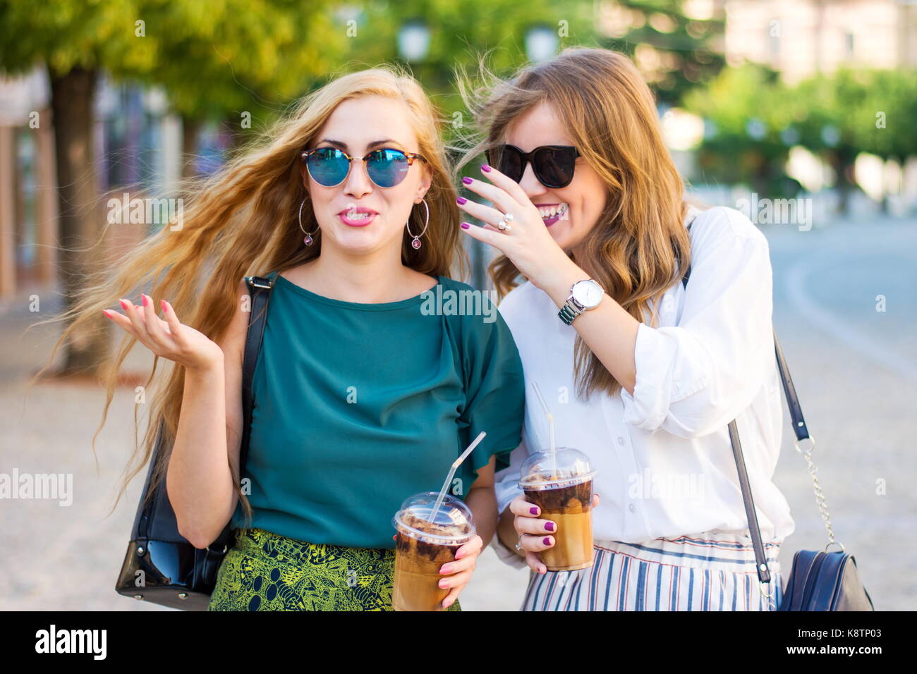 Happy girls walking around the city together Stock Photo - Alamy