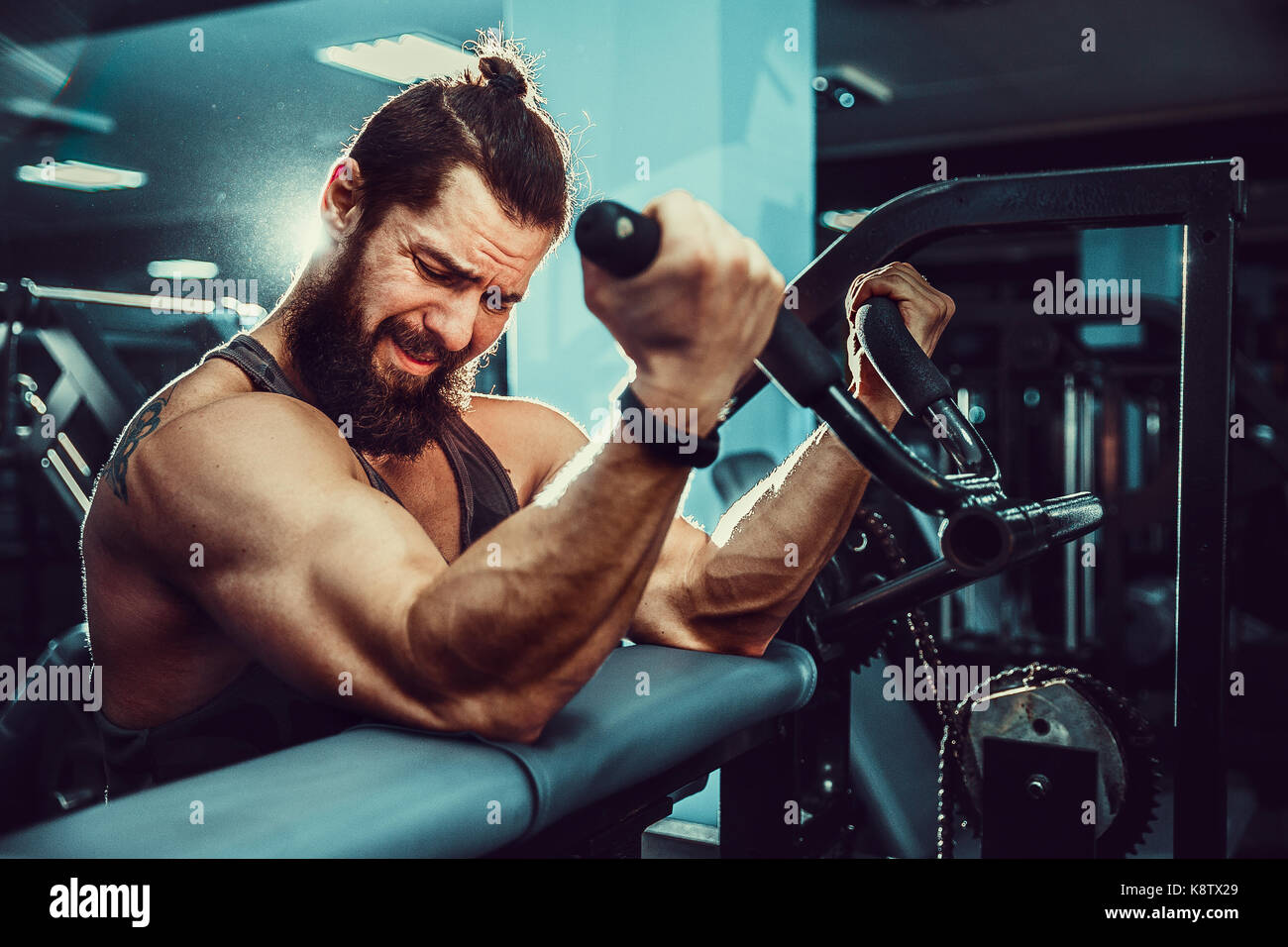 Man Doing Heavy Weight Exercise For Biceps On Machine In A Gym Stock ...