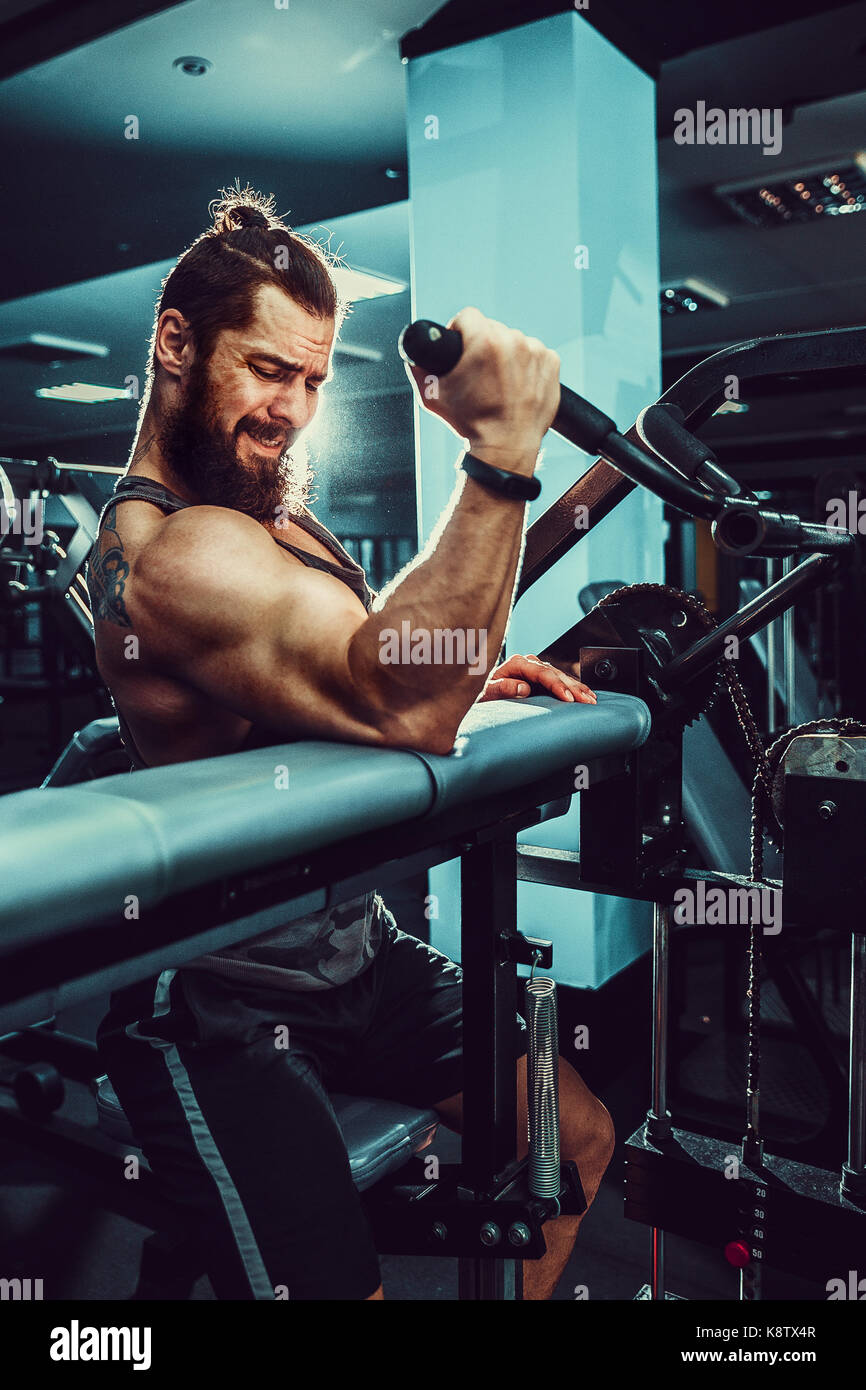 Man Doing Heavy Weight Exercise For Biceps On Machine In A Gym Stock ...