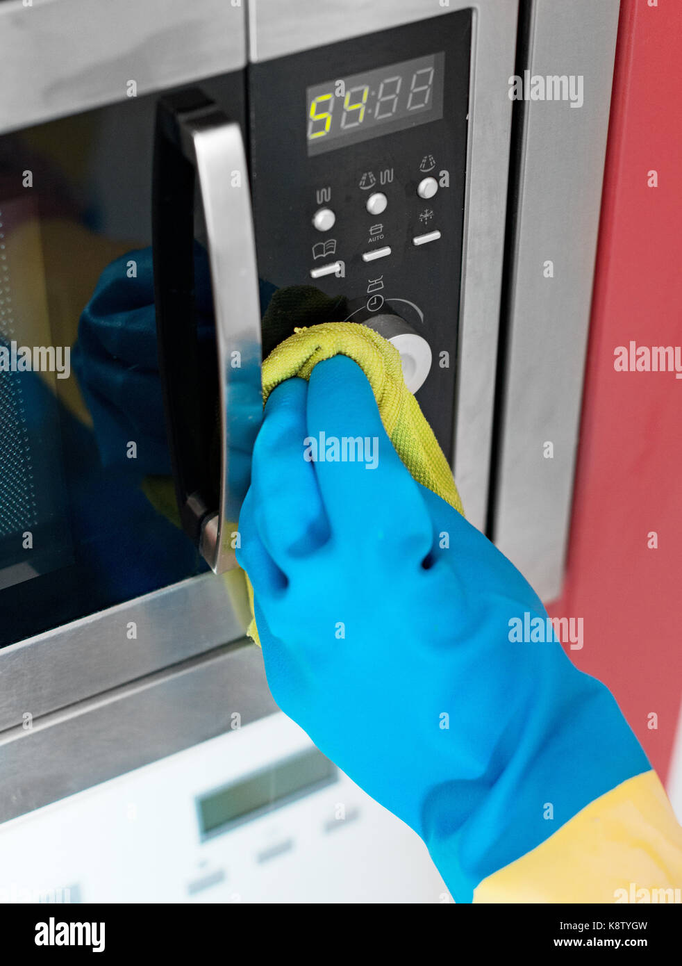 Woman wiping microwave oven hi-res stock photography and images - Alamy