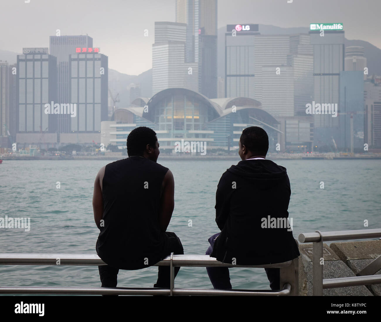Hong Kong Mar 29 2017 A Gay Couple Sitting On Embankment Of