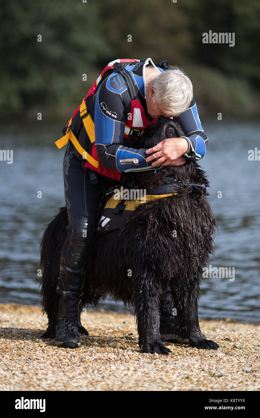 A rescue demonstrator from Pete Lewin's water safety dogs comforts a ...