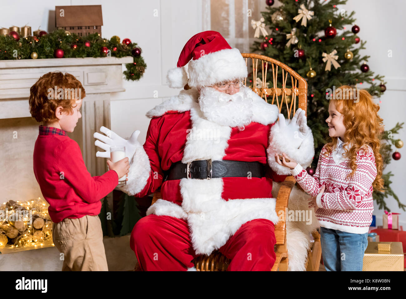 kids giving milk and cookie to santa Stock Photo - Alamy