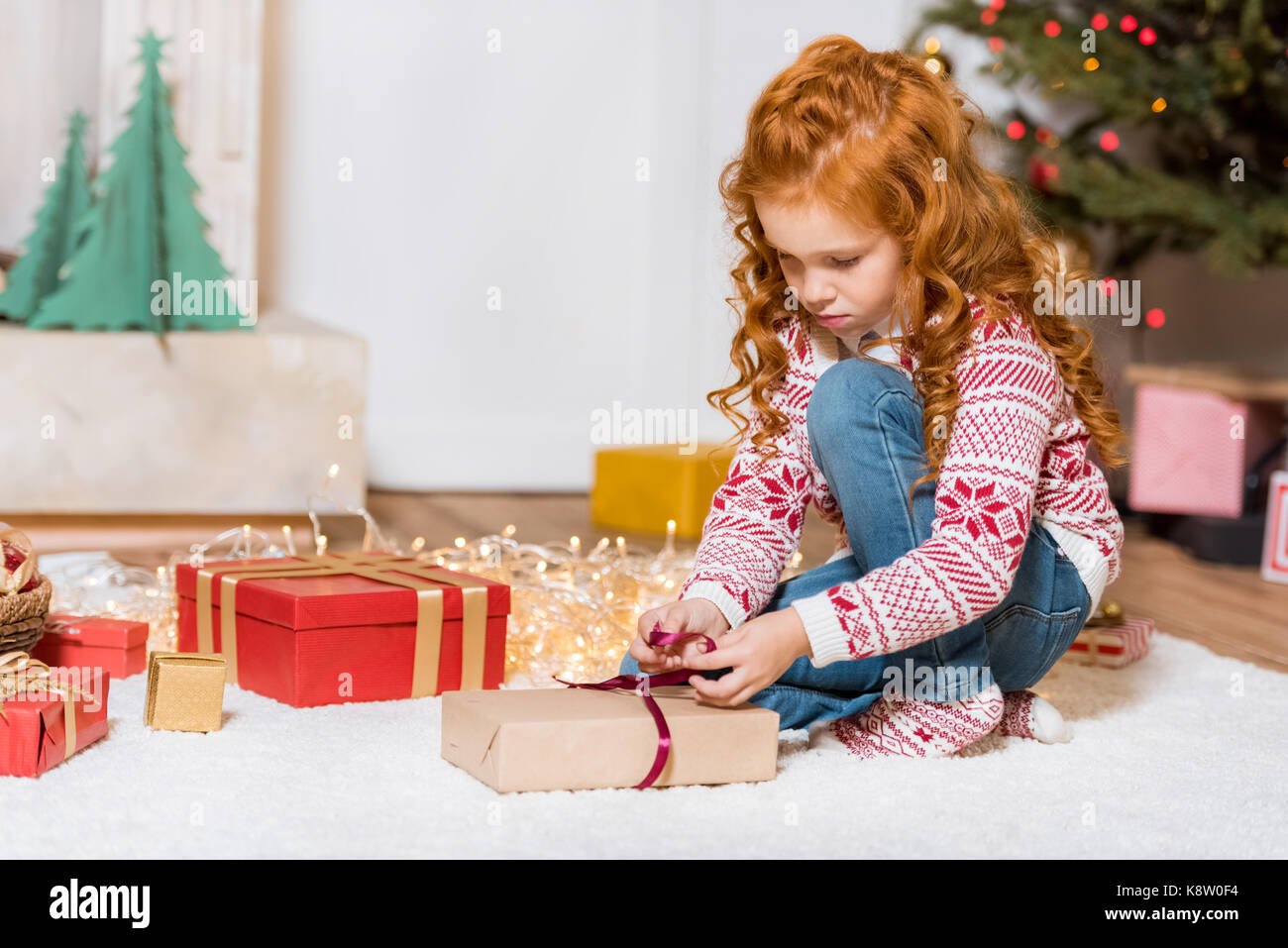 child unpacking christmas gift Stock Photo - Alamy