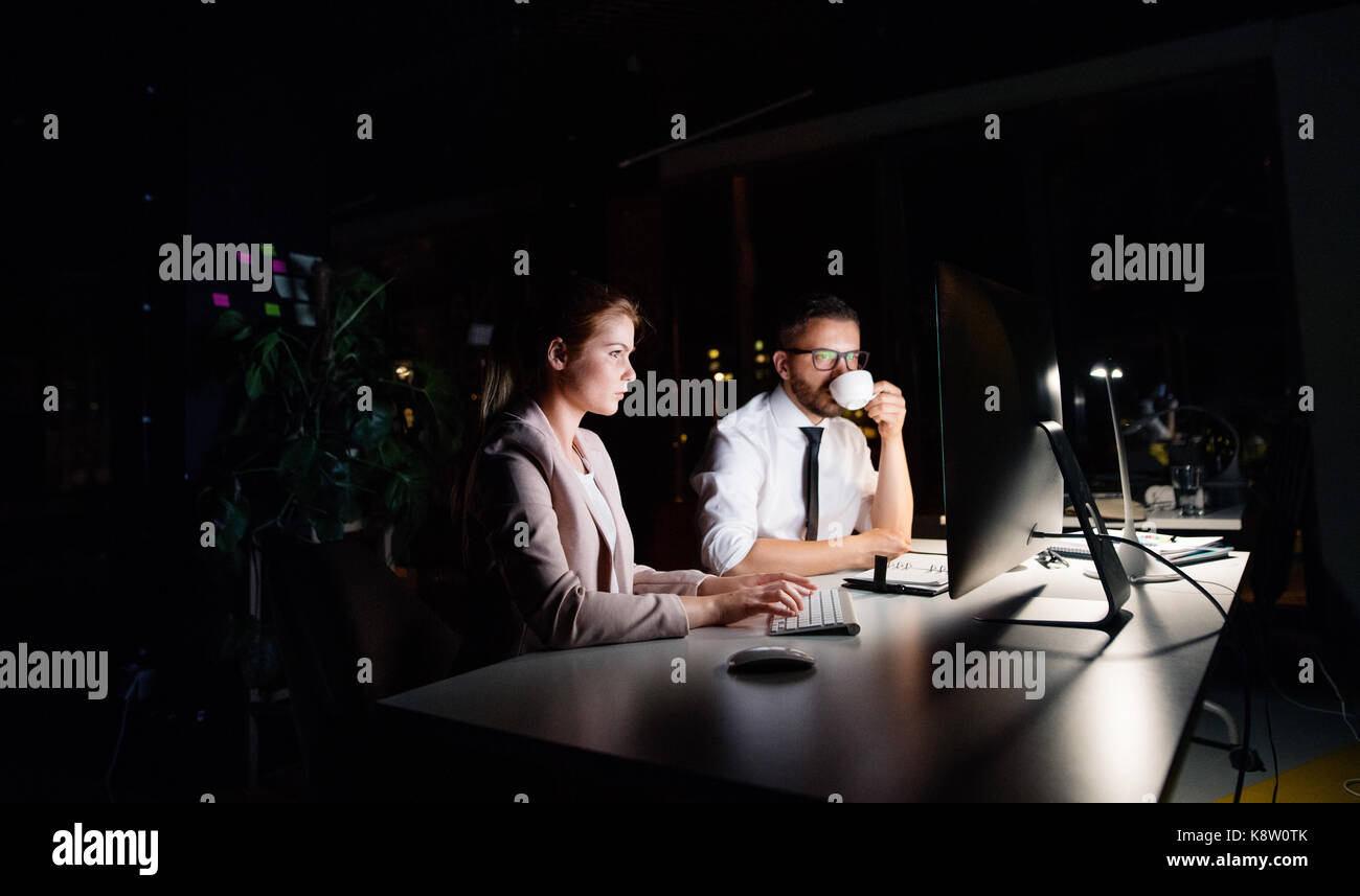 Businesspeople in the office at night working late Stock Photo - Alamy