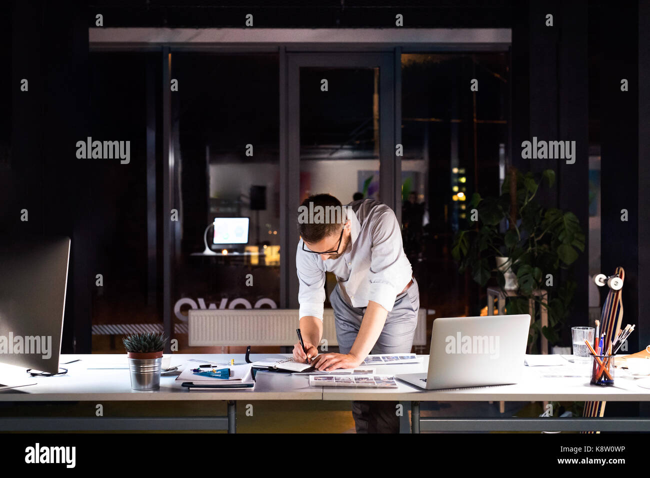 Businessman in the office at night working late Stock Photo - Alamy