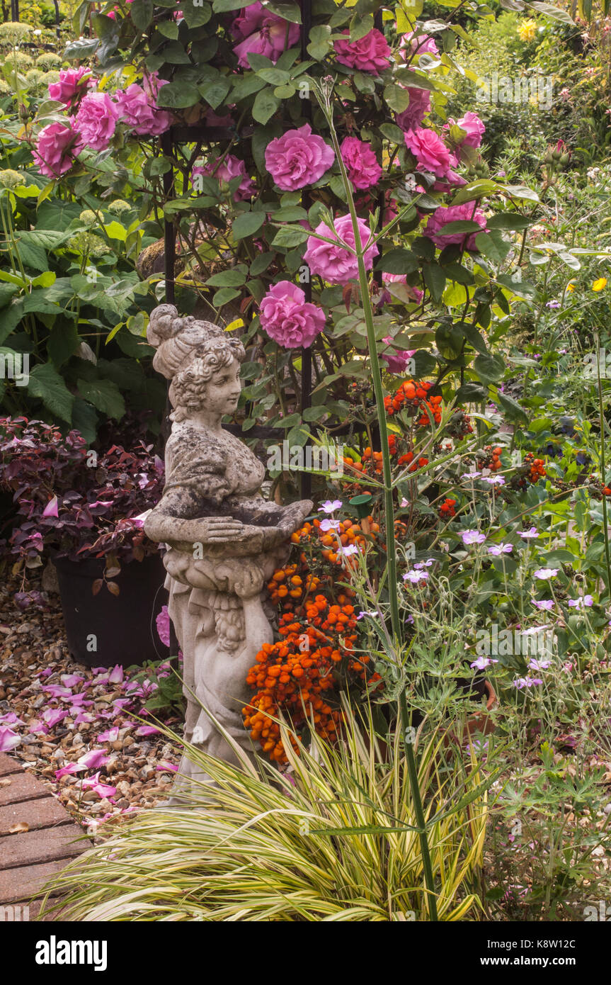 Romantic garden statue with roses Stock Photo - Alamy