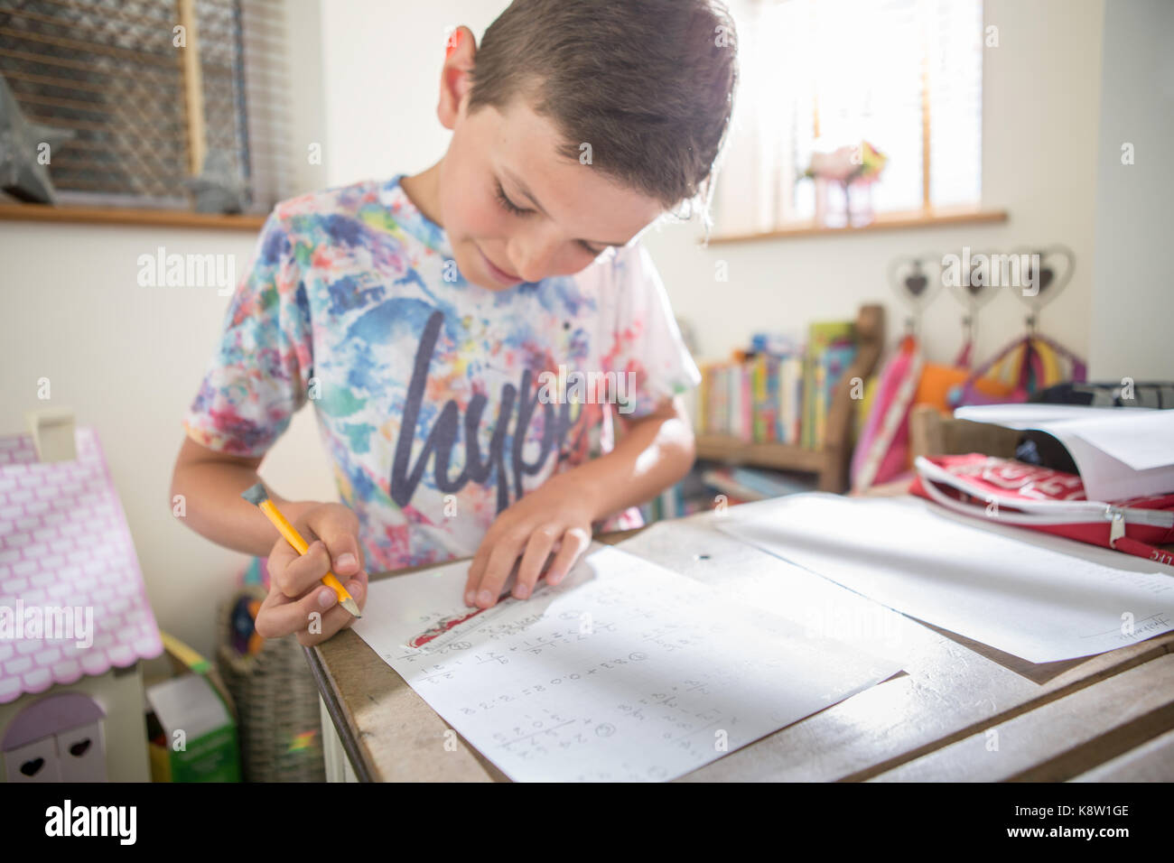 Teenage boy doing homework Stock Photo - Alamy