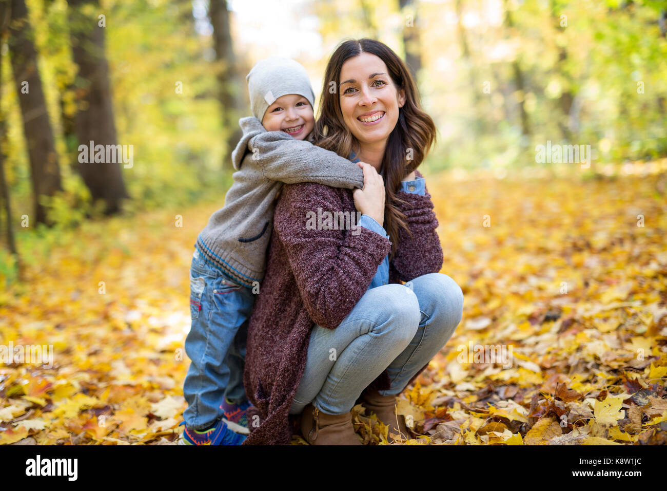 Mother with son in forest in autumn Stock Photo - Alamy
