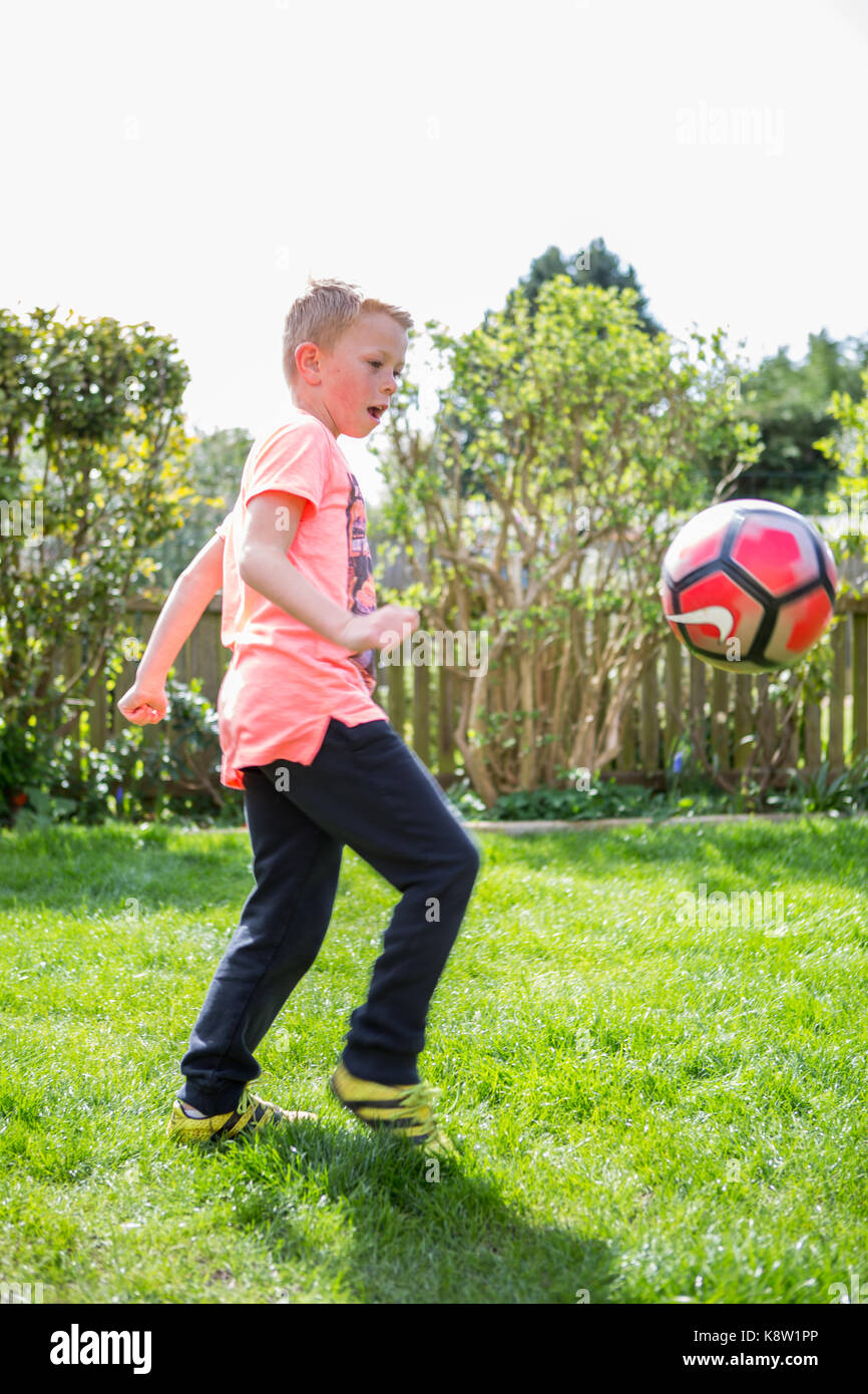 young boys playing football Stock Photo - Alamy