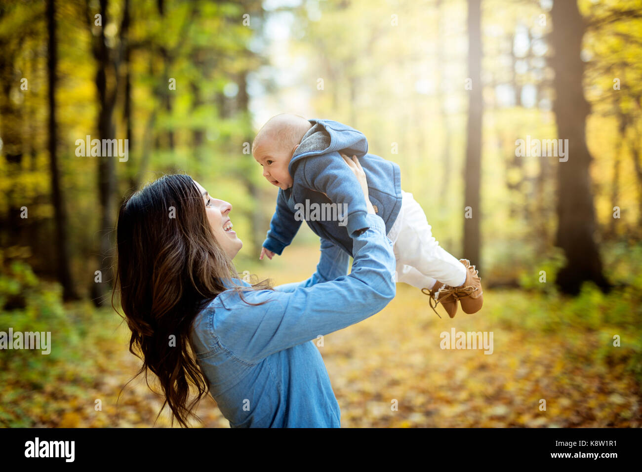 Mother with daughter baby in autumn forest Stock Photo - Alamy
