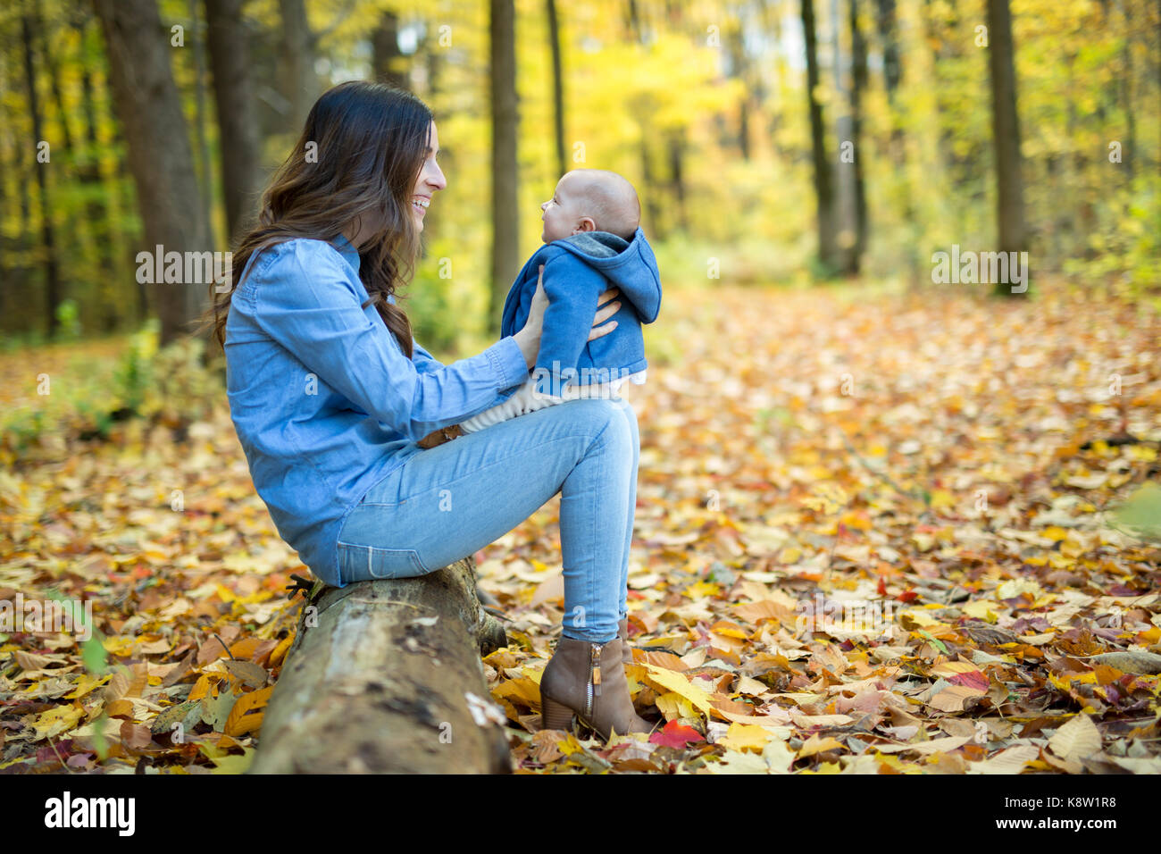 Mother with daughter baby in autumn forest Stock Photo - Alamy