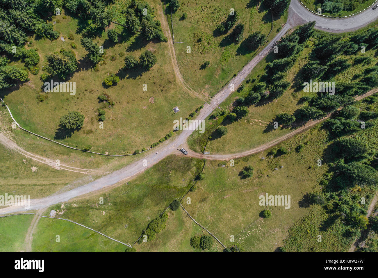 Aerial view over mountain road going through forest landscape Stock ...