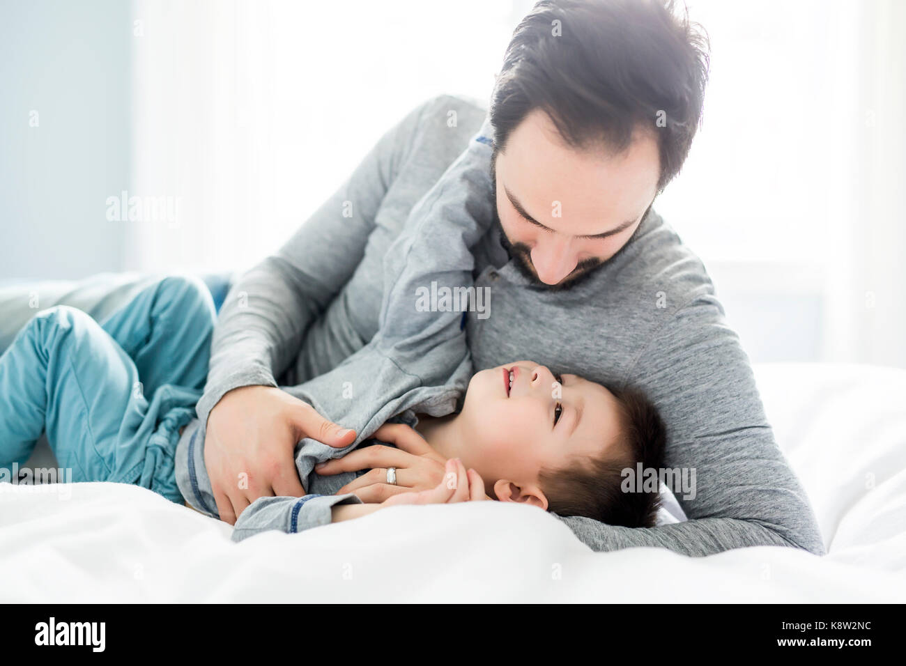 Father and son in bed, happy time on bed Stock Photo - Alamy