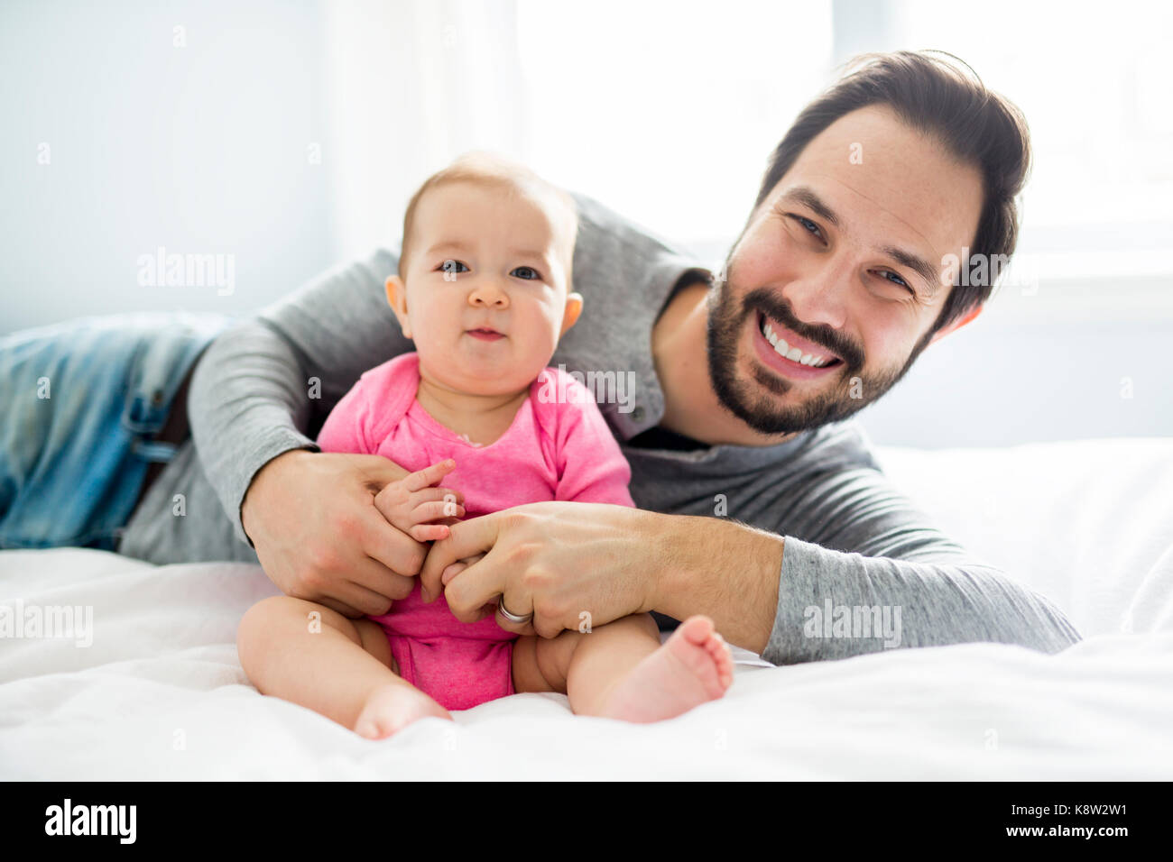 happy father playing with adorable baby in bedroom Stock Photo - Alamy