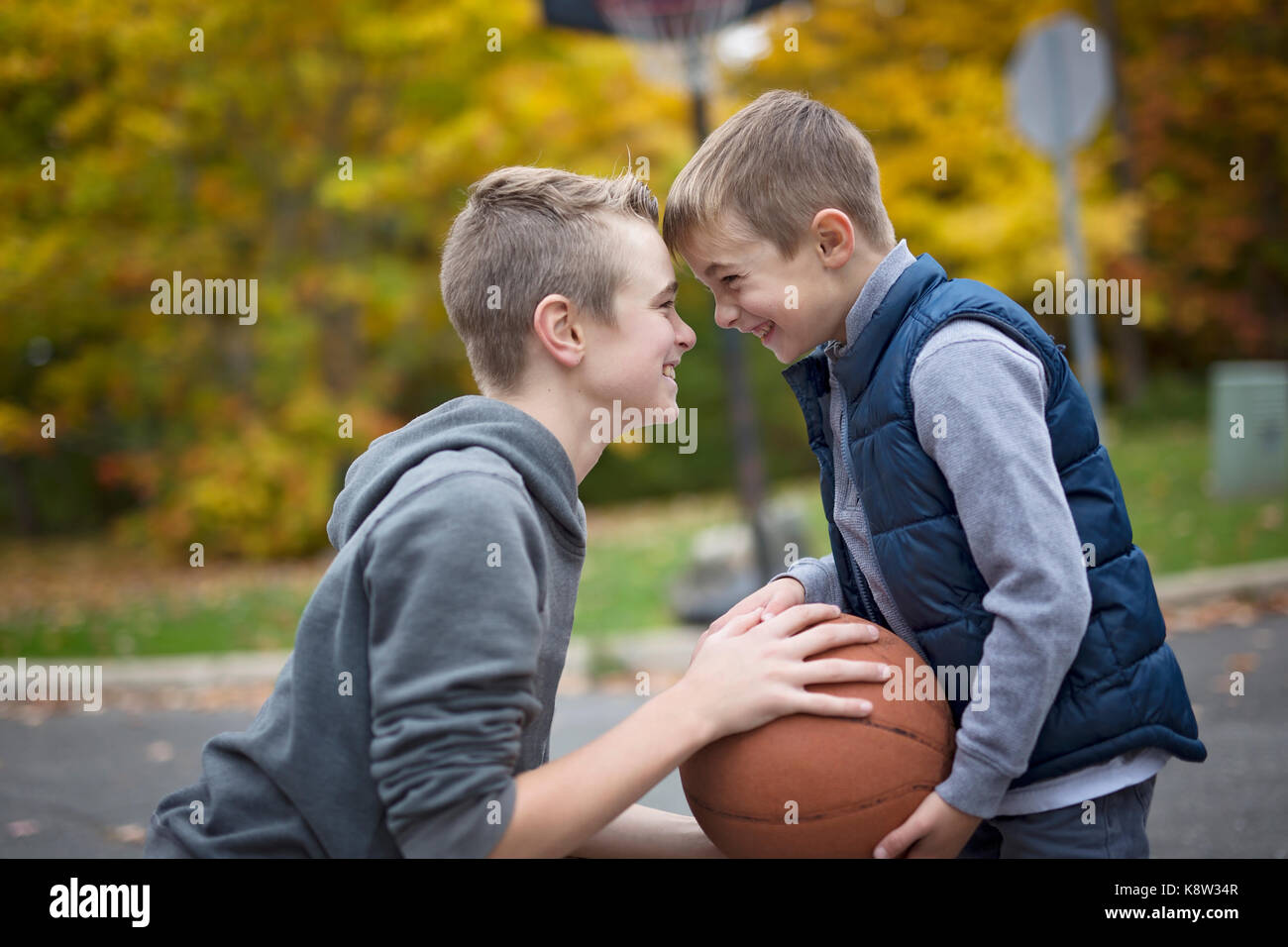 two boys with a basket ball Stock Photo - Alamy