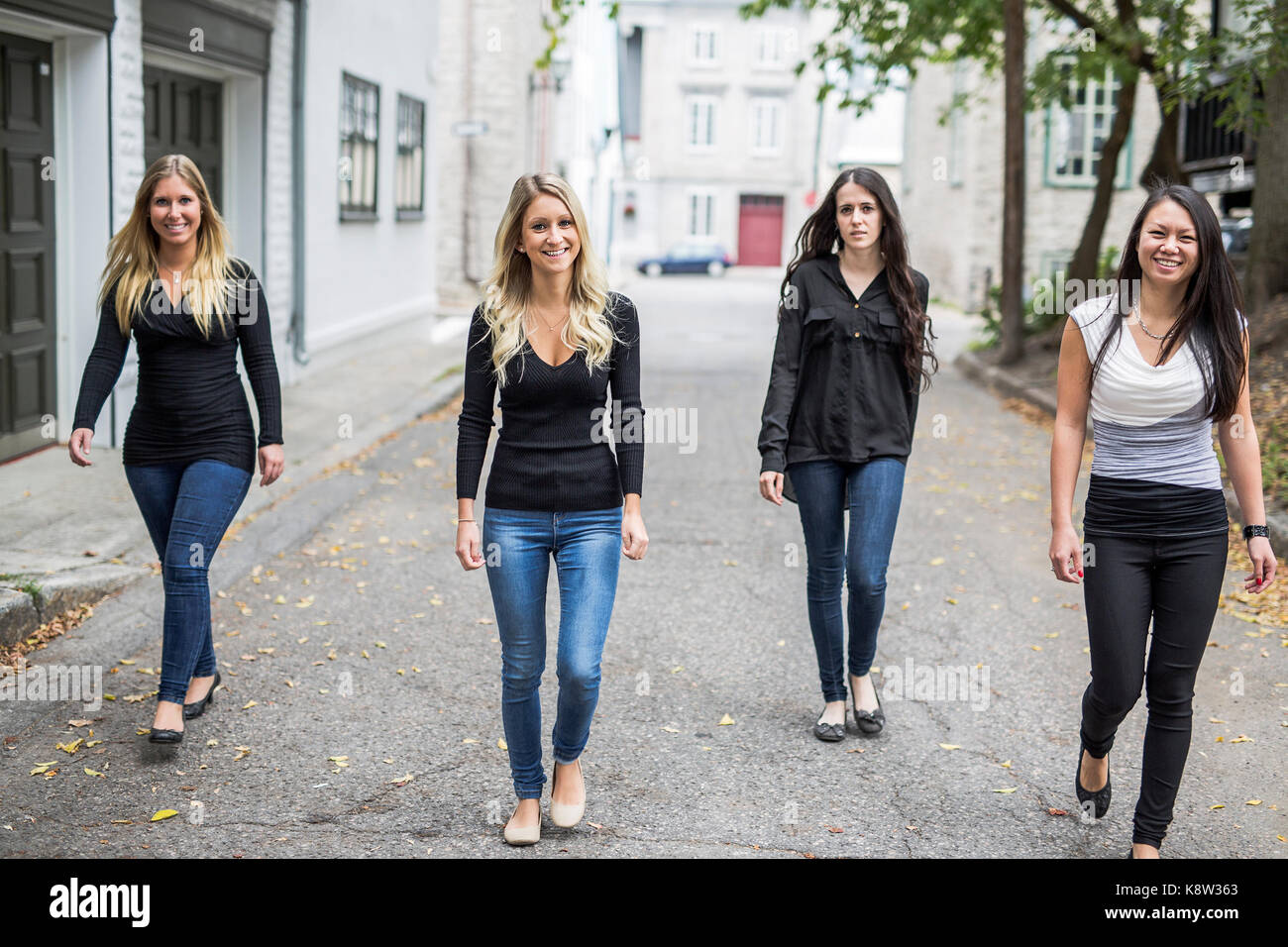 Four young good girl friend people in the city Stock Photo - Alamy