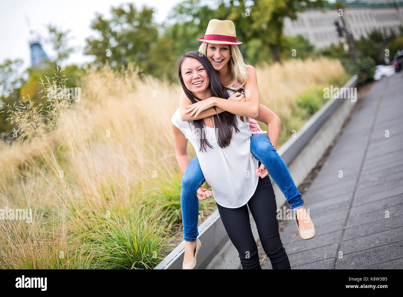 two beautiful young women having fun in the city Stock Photo - Alamy