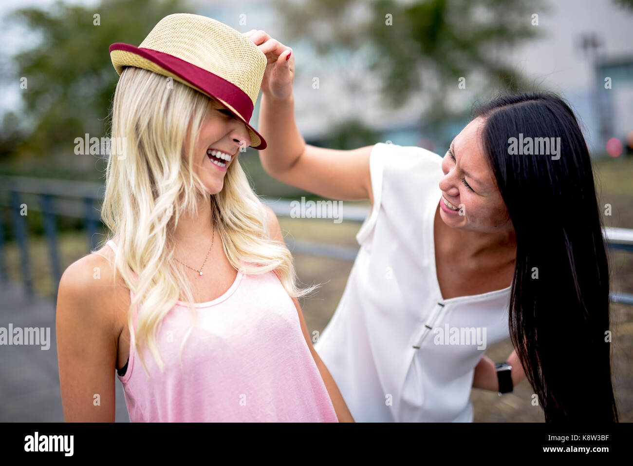 two beautiful young women having fun in the city Stock Photo - Alamy