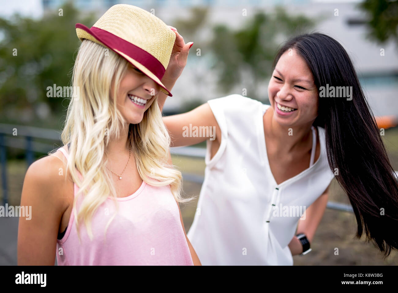 two beautiful young women having fun in the city Stock Photo - Alamy
