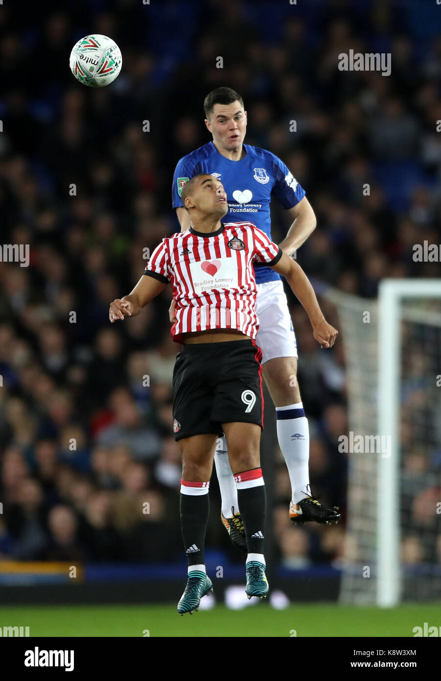 Sunderland's James Vaughan and Everton's Michael Keane jump for the ...