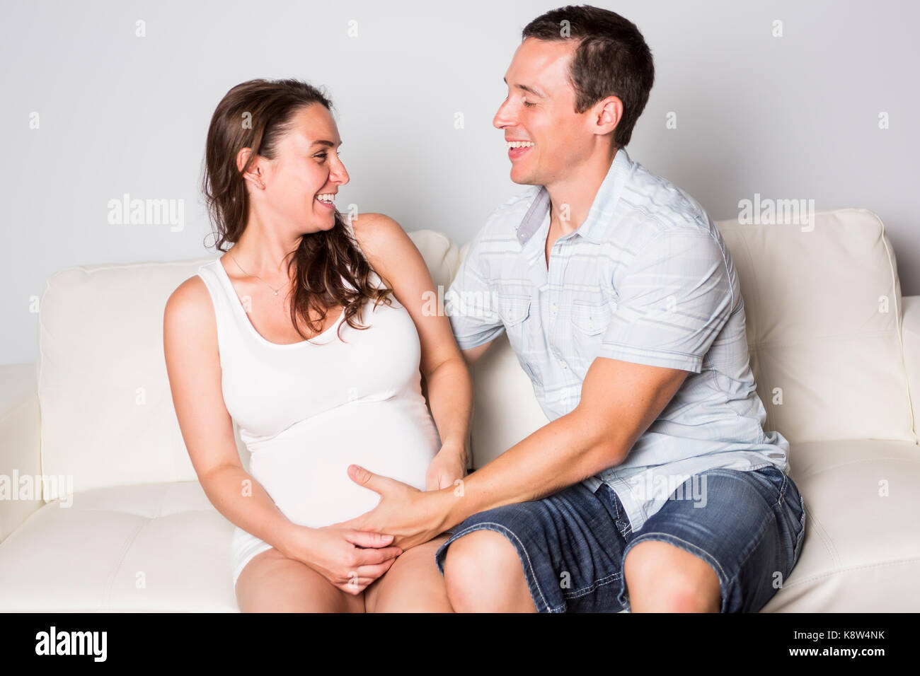 Young pregnant couple lying hi-res stock photography and images - Alamy
