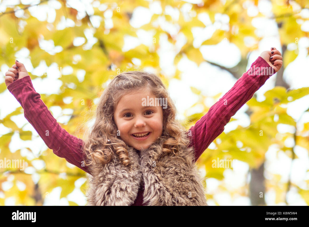 Adorable little girl in a autumn forest Stock Photo - Alamy