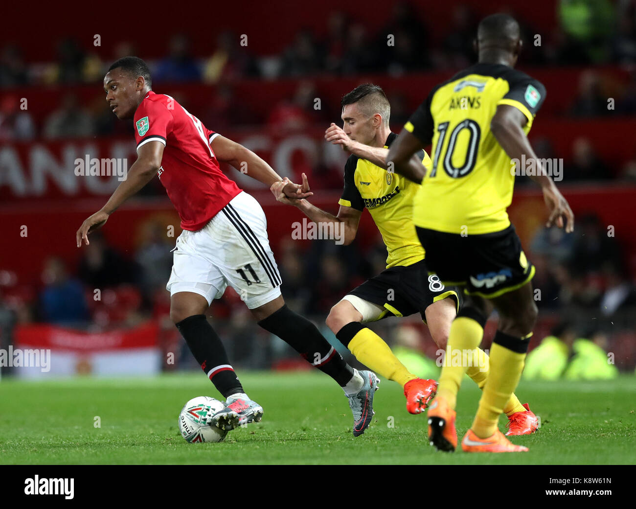 Burton Albion's Matthew Lund pulls back on Manchester United's Anthony ...