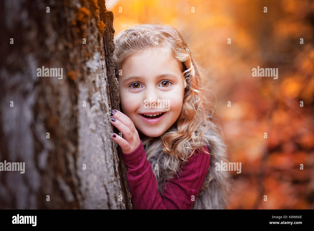 Adorable little girl in a autumn forest Stock Photo - Alamy